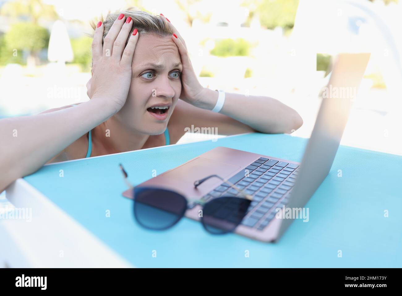 Woman using laptop swimming pool hi-res stock photography and images ...