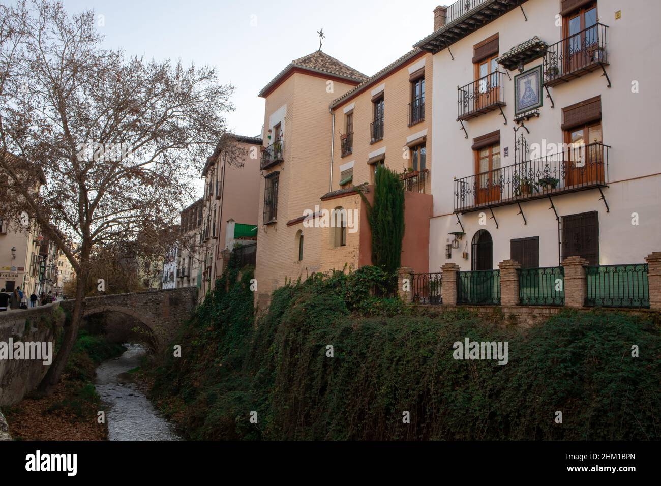 The Darro River on its way through Granada with a bridge Stock Photo ...