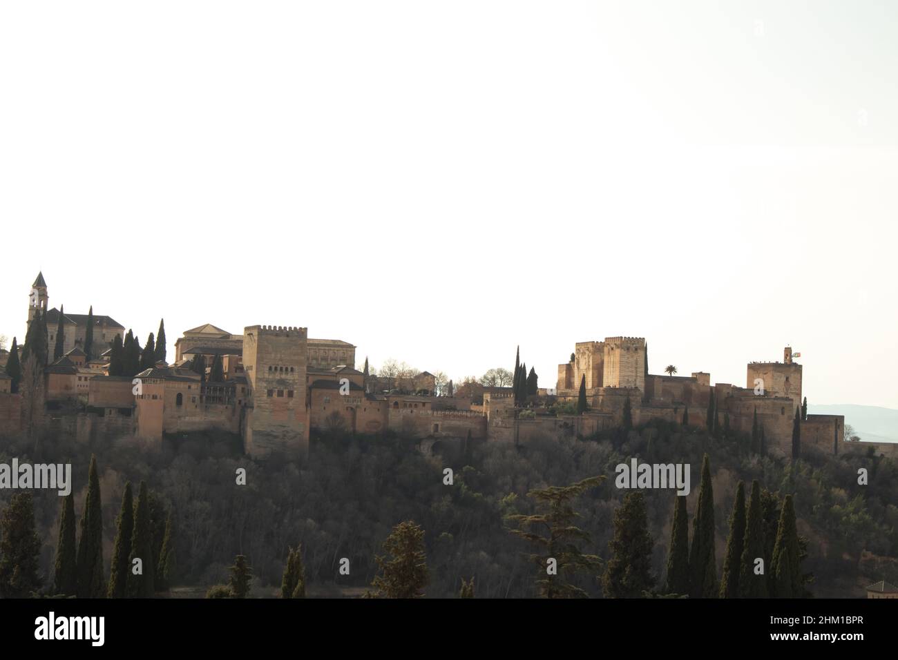 view of Alhambra Palace in Granada, Spain with Sierra Nevada mountains ...