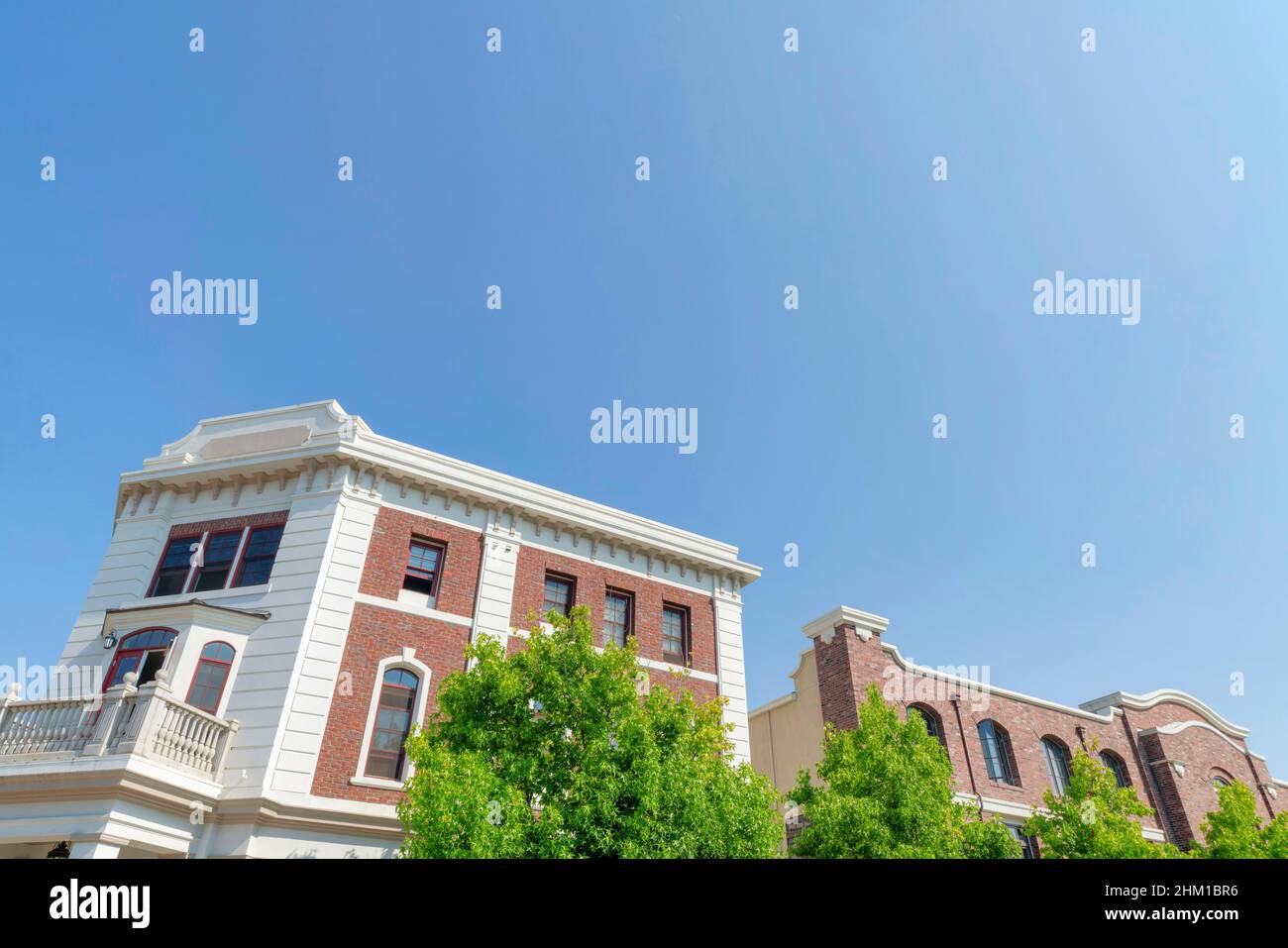 Two buildings with red bricks and white wall claddings at San Marcos ...