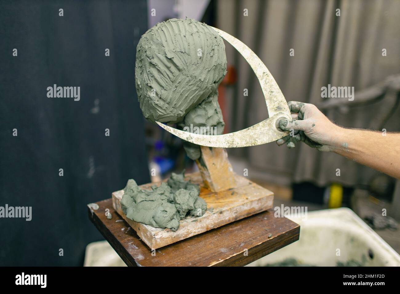 Man sculptor creates sculpt bust clay human measures compass woman head ...