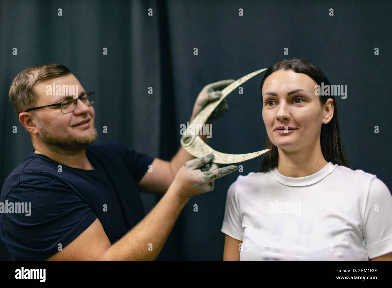 Man sculptor creates sculpt bust clay human measures compass woman head ...