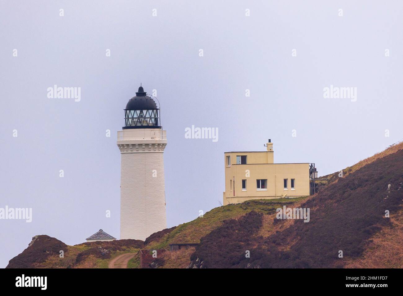 lighthouse and a small house on a slope Stock Photo - Alamy