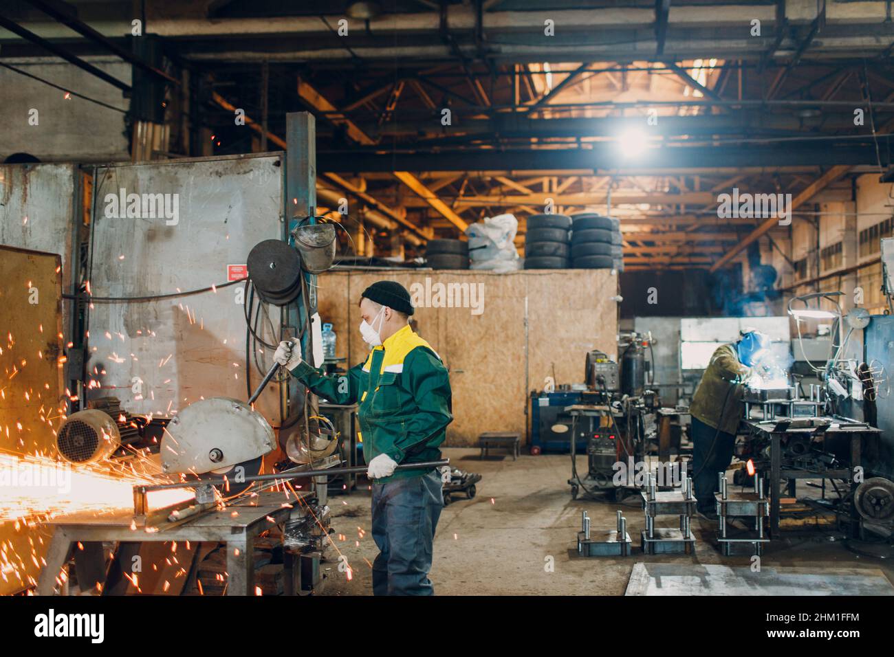 Workers working with metal construction on plant. Metal processing with ...