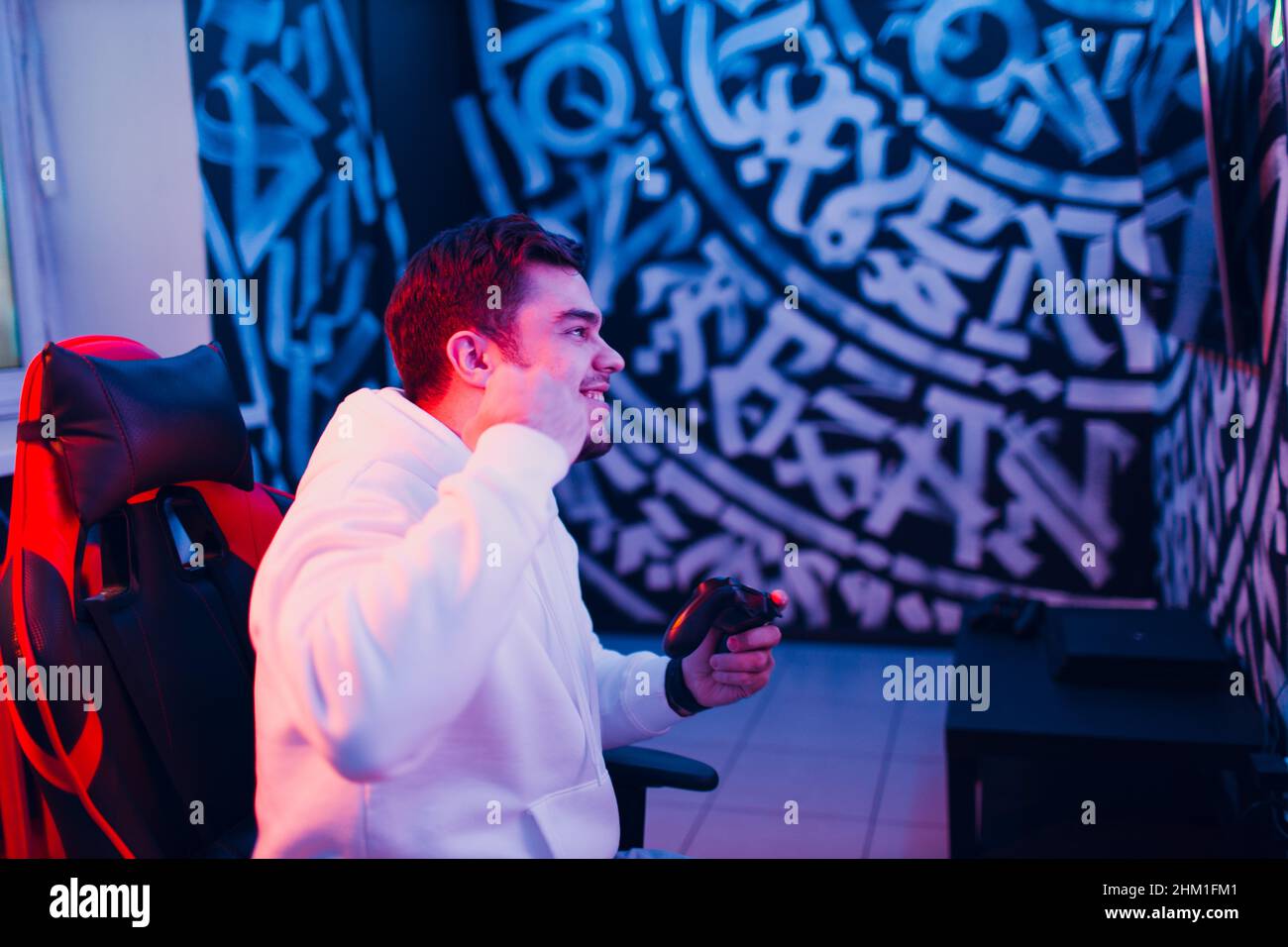 Guy young adult man gamer playing video game on game console at ...
