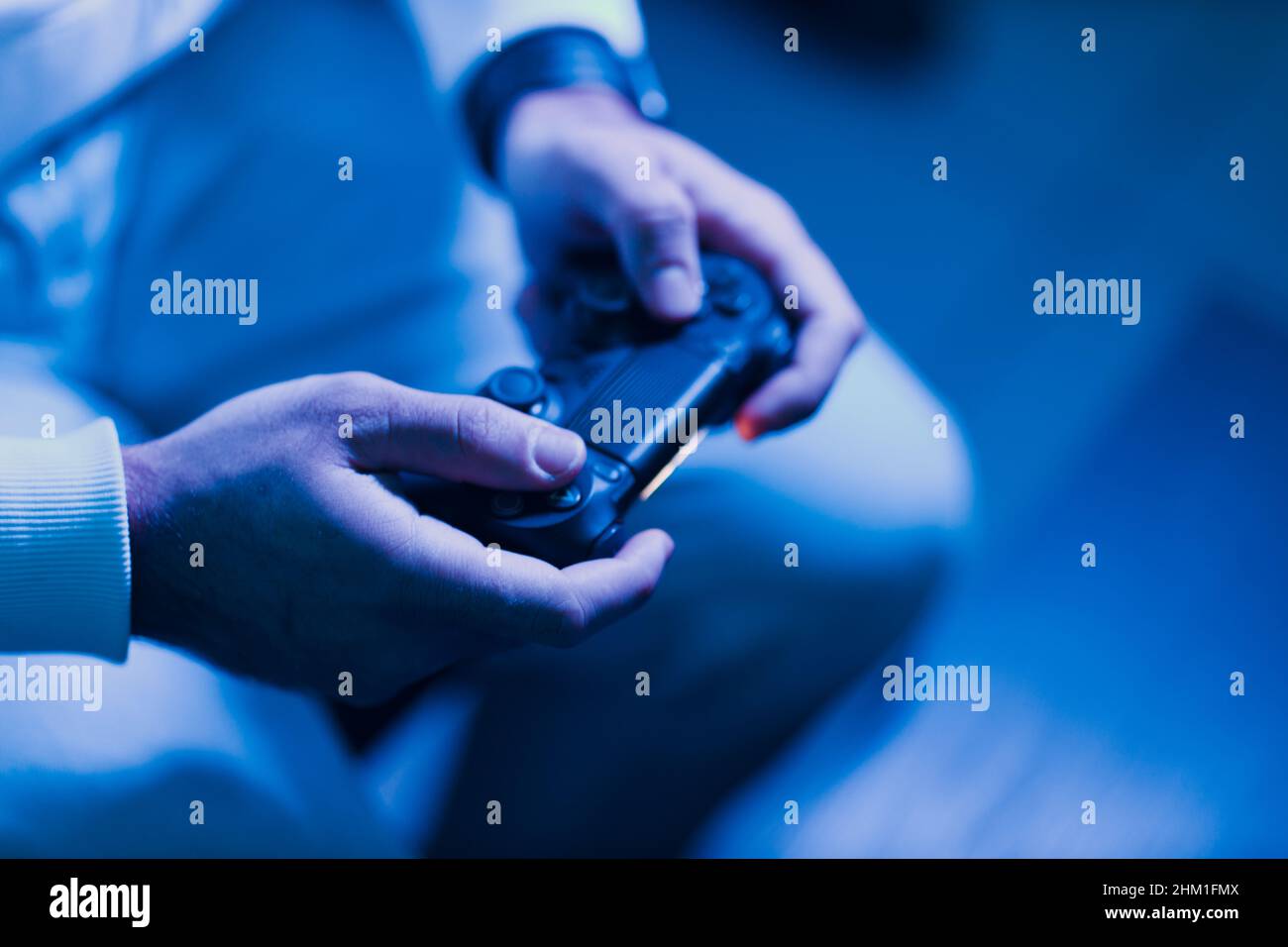 Guy young adult man gamer playing video game on game console hold ...