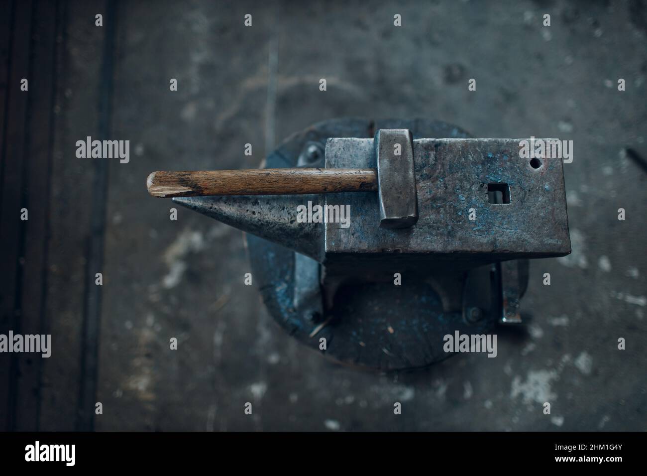 Blacksmith's hammer on metal anvil at forge. Overhead view Stock Photo ...