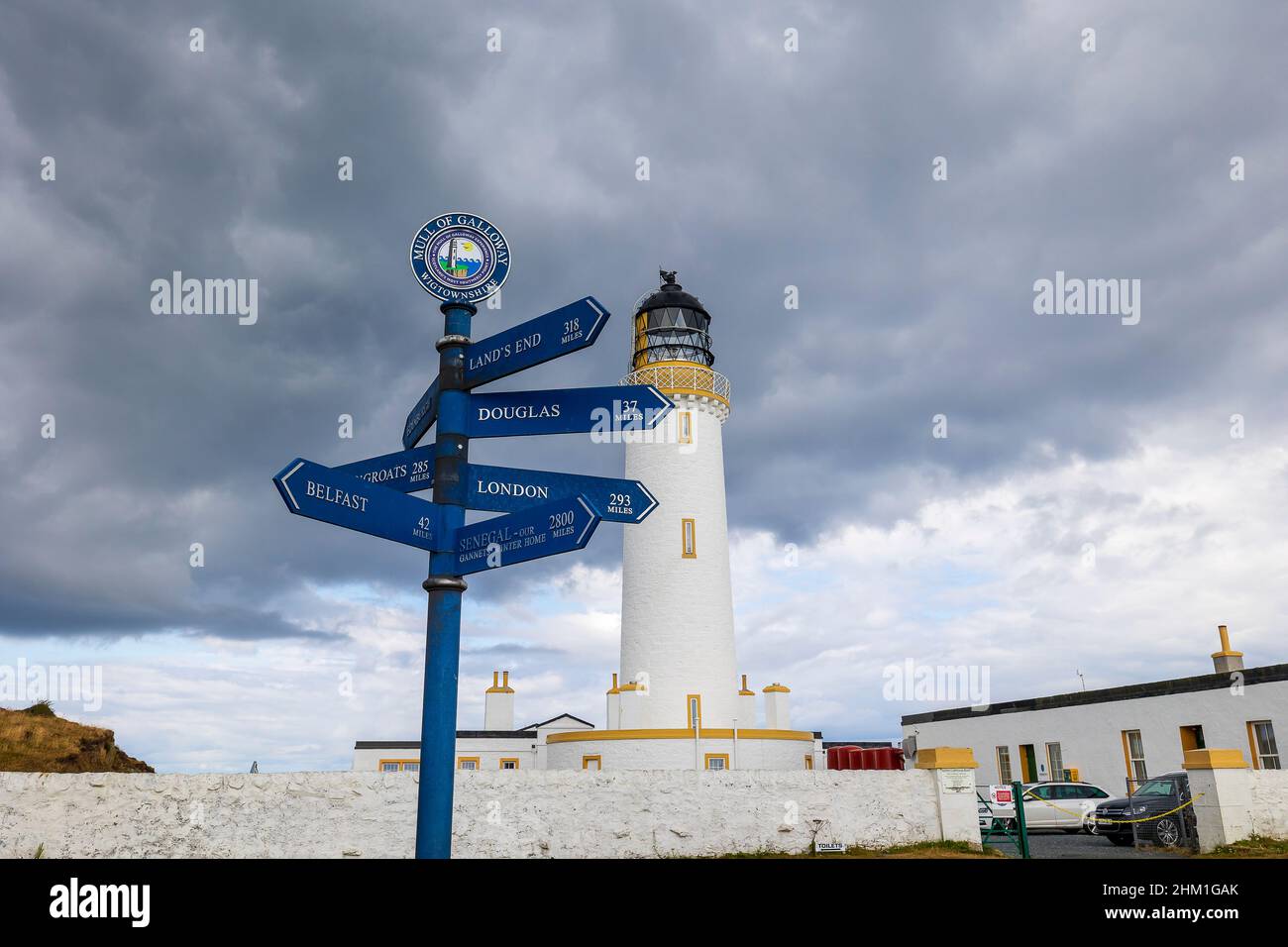 Horizontal photo of a lighthouse with direction and distance signs to ...