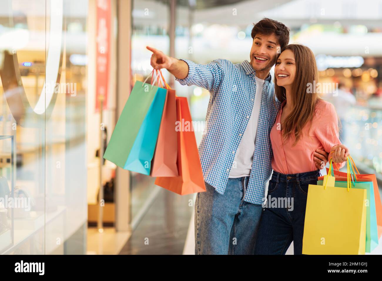 Couple Shopping Together, Husband Pointing Finger At Shop In Mall Stock ...