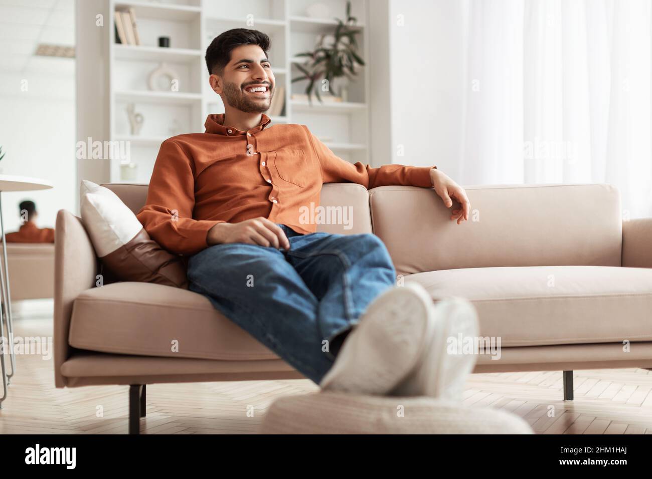 Man having rest at home on the couch Stock Photo - Alamy