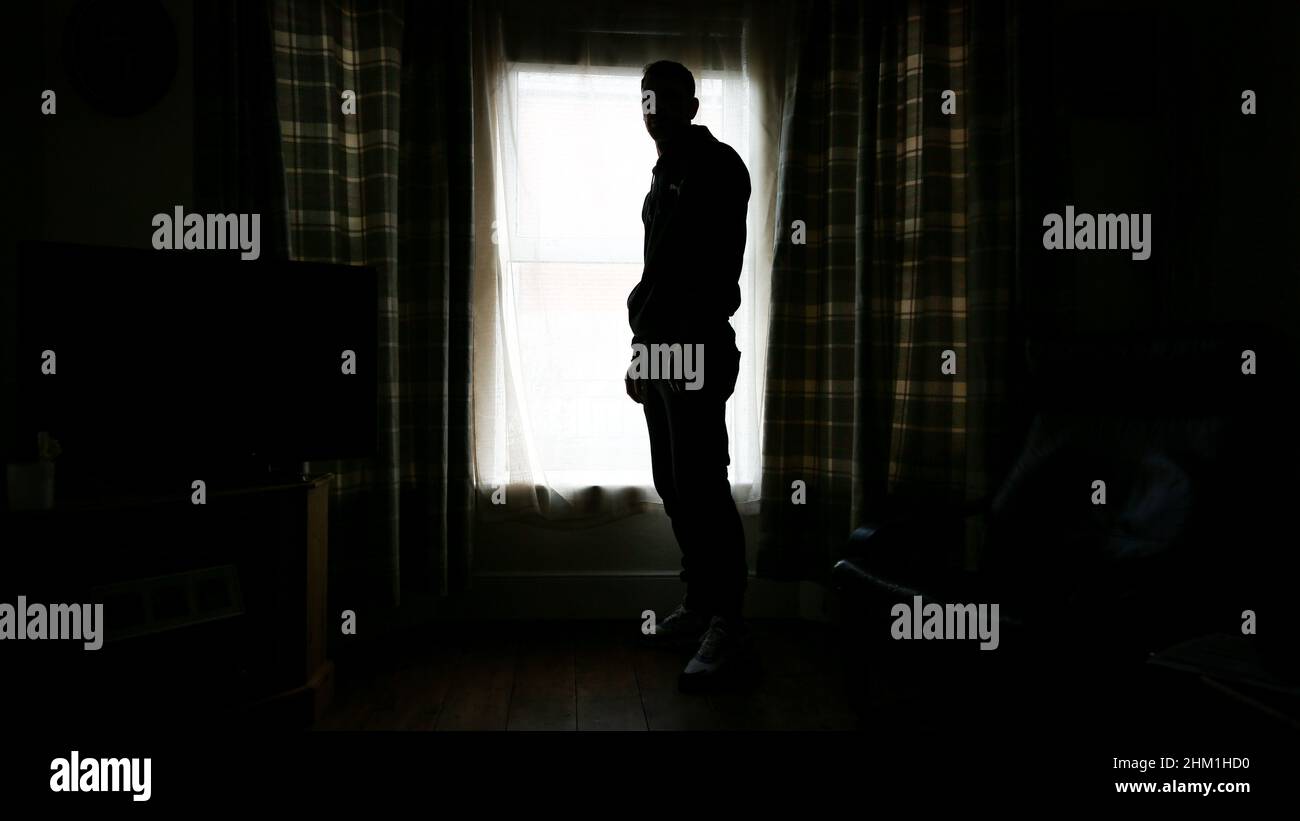 SALISBURY, UK. A man stood by the bay windows of a house in Lower ...