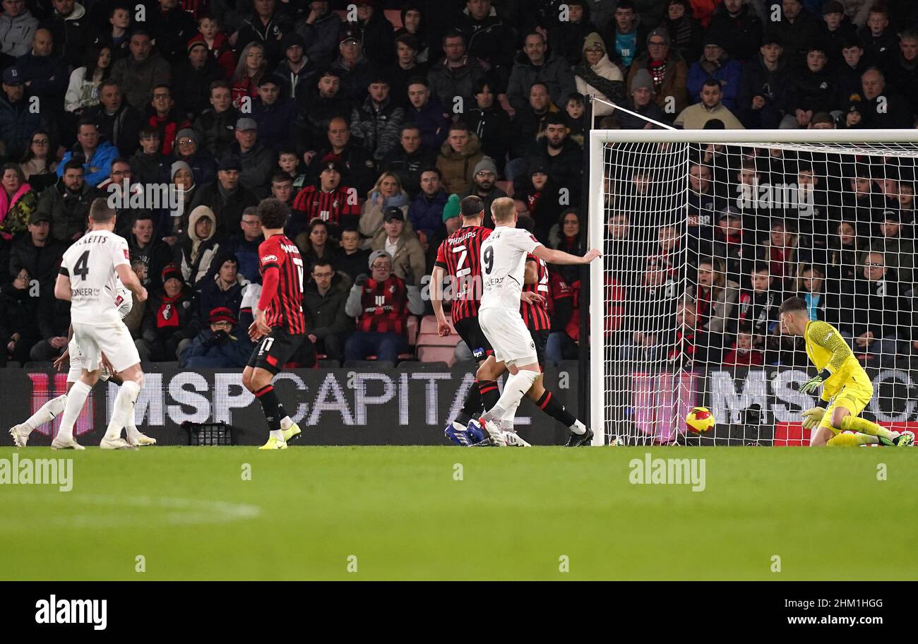 Boreham Wood's Mark Ricketts (left) scores their side's first goal of ...