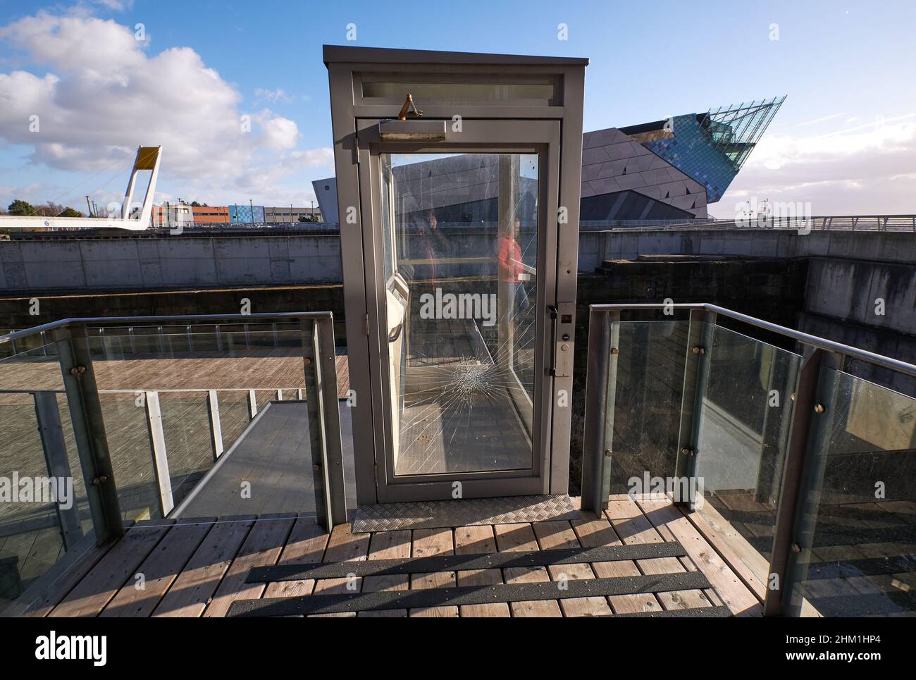 Damaged glass door of a public lift Stock Photo - Alamy
