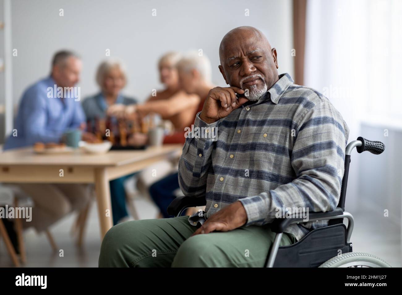 Disabled African American Senior Man In Wheelchair Feeling Lonely Stock