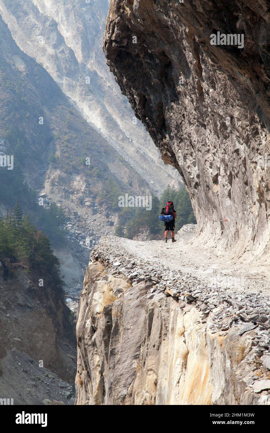man on the way, rock and road in round Annapurna circuit trekking trail ...