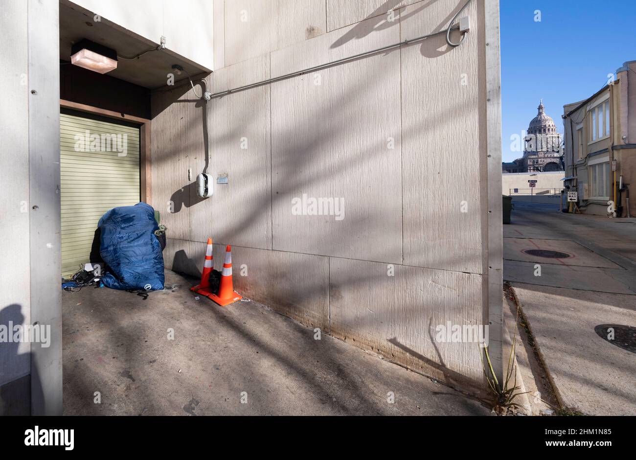 February 6, 2022: A homeless person bundles up in a sleeping bag within ...