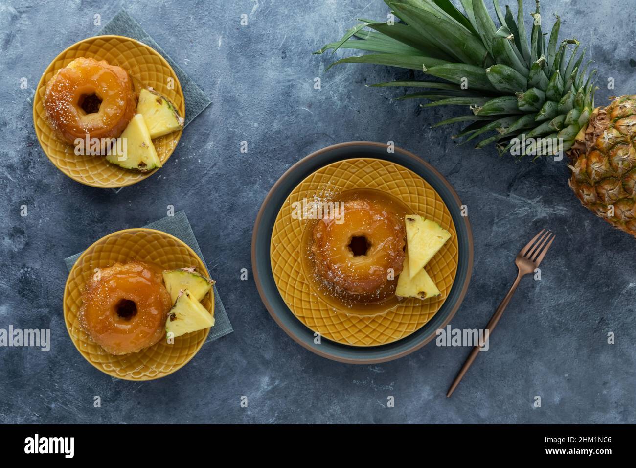 Top down view of servings of pineapple upside down cake and slices of ...
