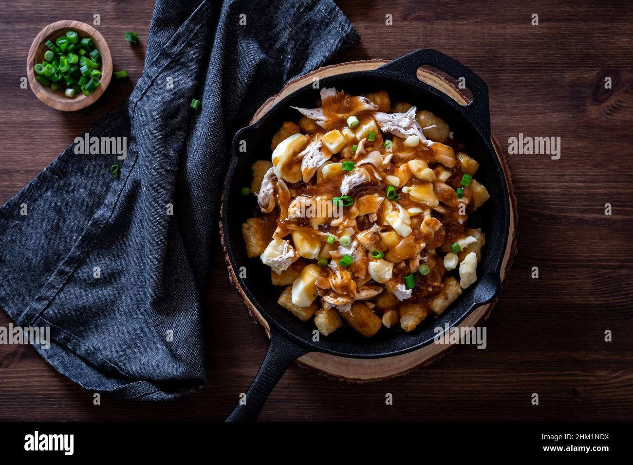 Poutine tater tot nachos, against a dark background, ready for snacking ...