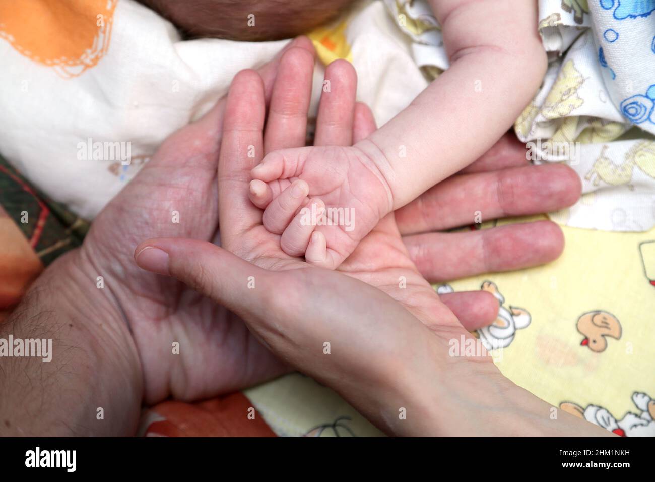 Baby sleeping with mothers hand hi-res stock photography and images - Alamy