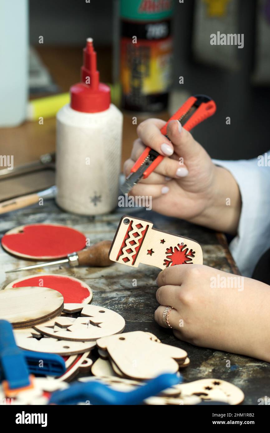 Closeup process making handmade wooden Christmas toys in carpentry ...