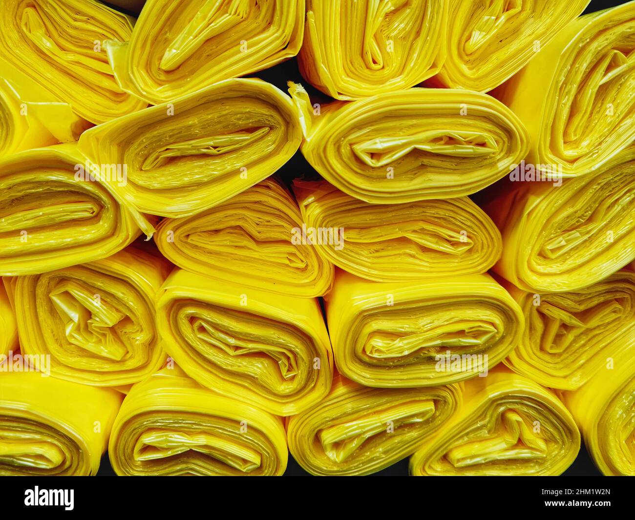 Close-up shot of a stack of yellow plastic bags. Great for background ...