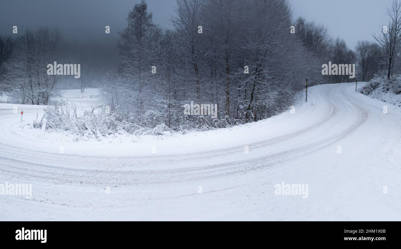 Dangerous mountain asphalt road during heavy snowfall, bad weather, fog ...