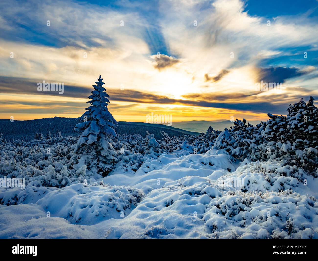 Scenic snowy landscape with a view from a mounatin range to the valley ...