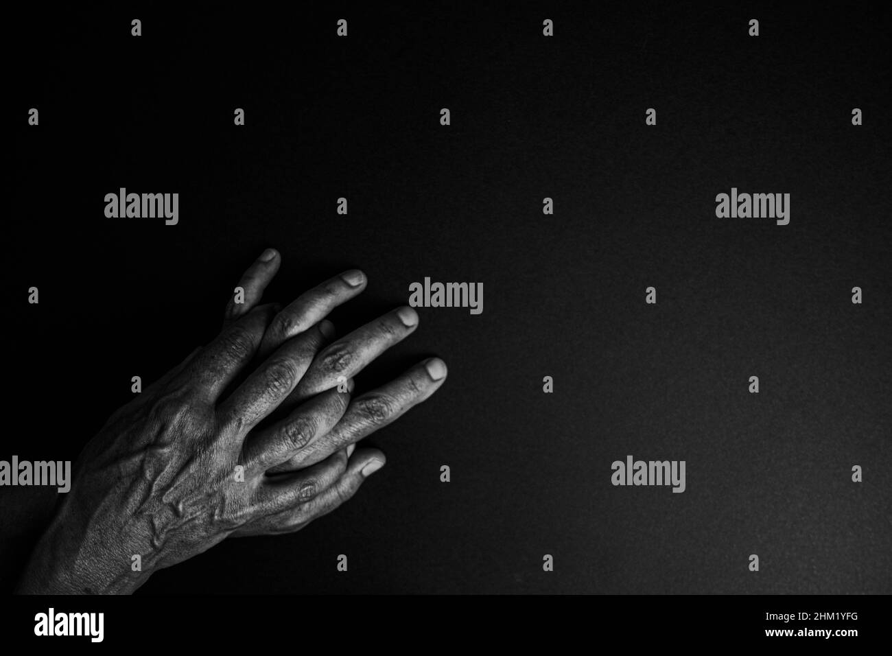 Two old hands in black and white poking out from one corner Stock Photo ...