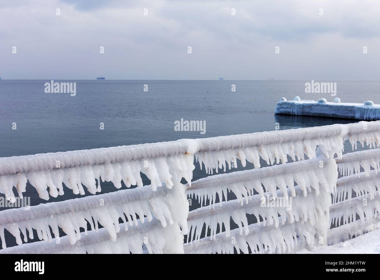 Snow and ice on the sea promenade. Icing seaside promenade after a ...