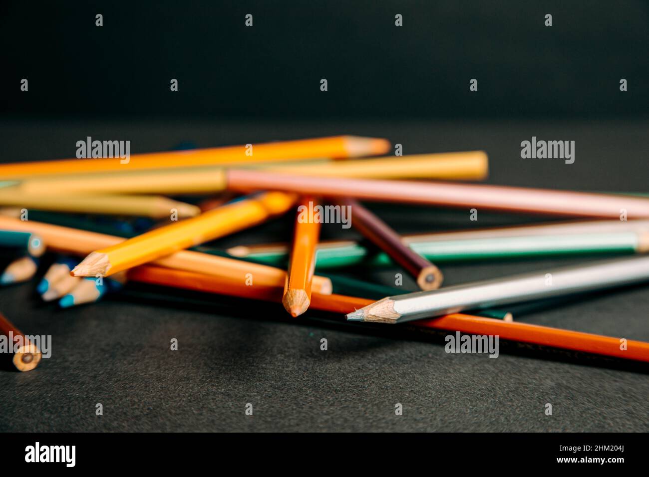 Bokeh view of a bunch of pencils lying on each other Stock Photo - Alamy