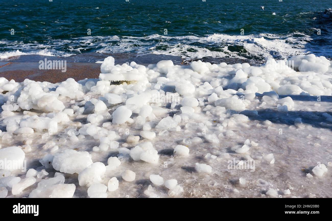 Snow and ice on the sea promenade. Icing seaside promenade after a ...