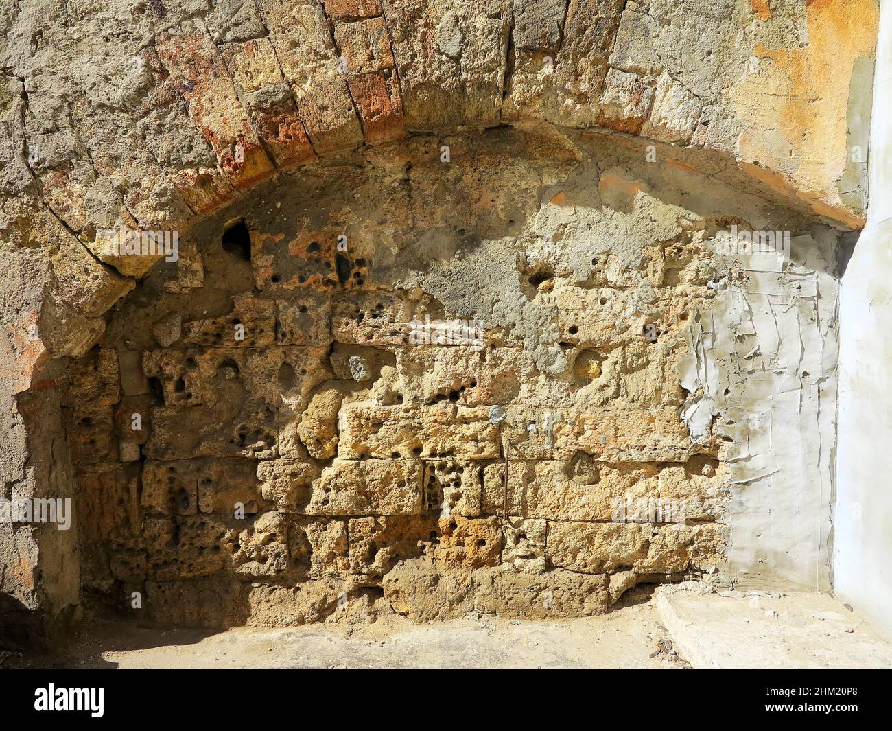 Entry and exit to the catacombs laid wall of natural stone Stock Photo ...
