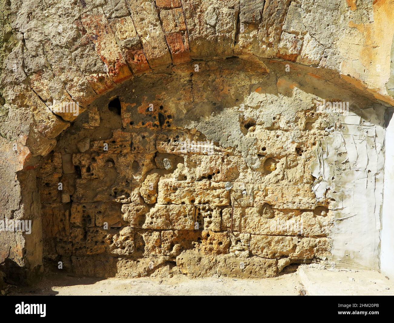 Entry and exit to the catacombs laid wall of natural stone Stock Photo ...