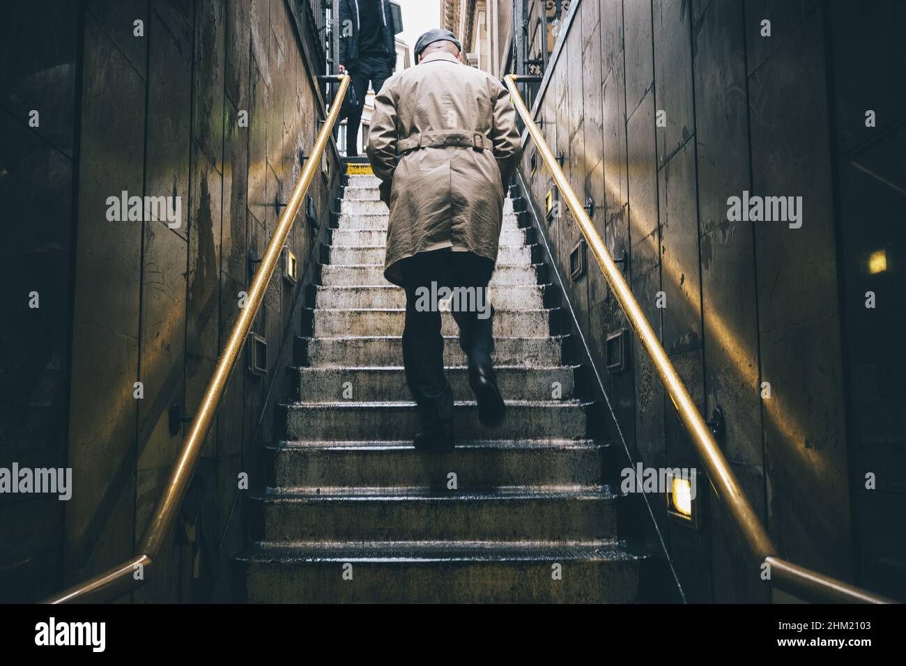 unknown older man walking up the old stone stairs during rain Stock ...
