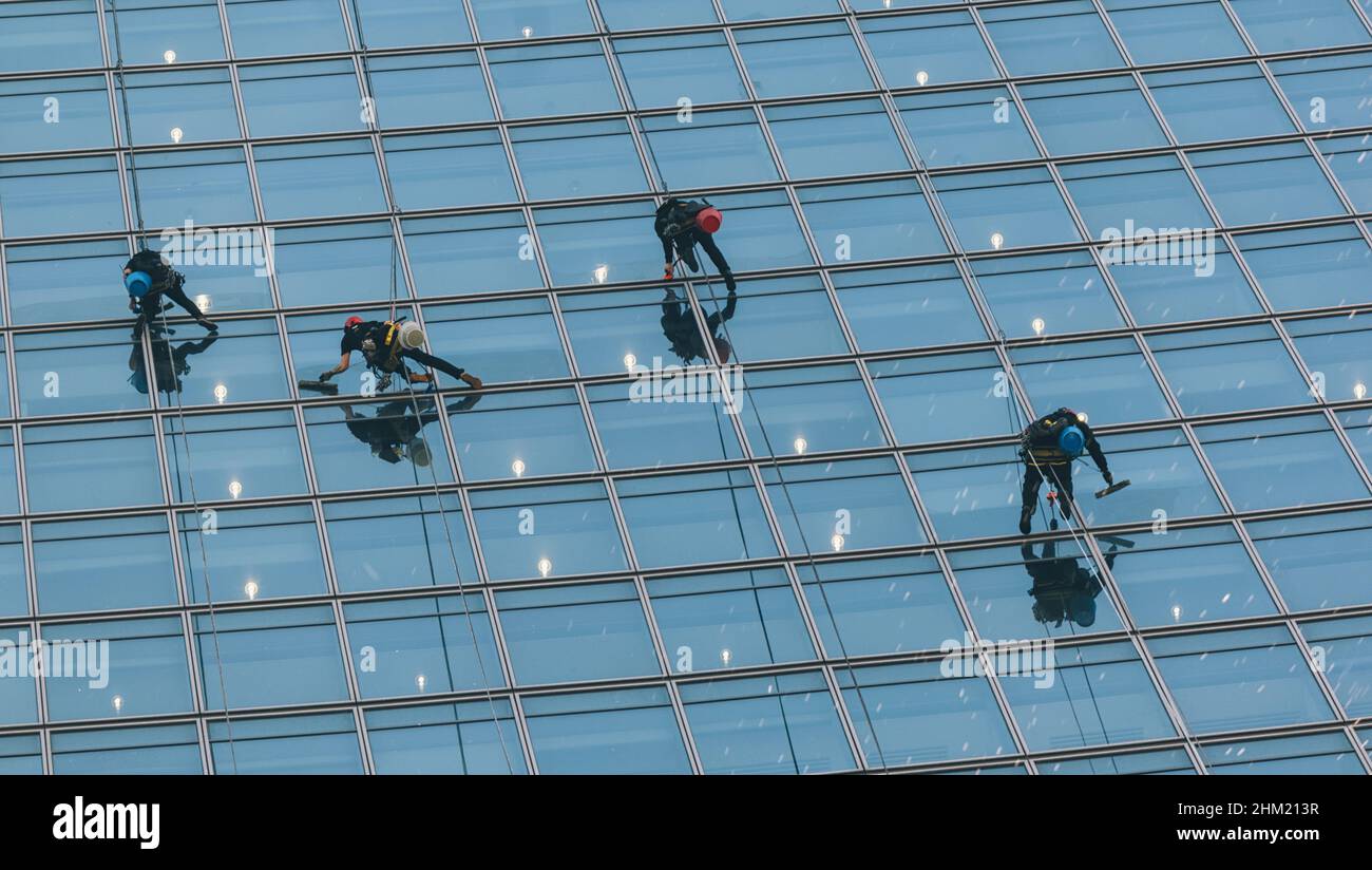 Washer wash the windows of high skyscraper, high risk work Stock Photo ...
