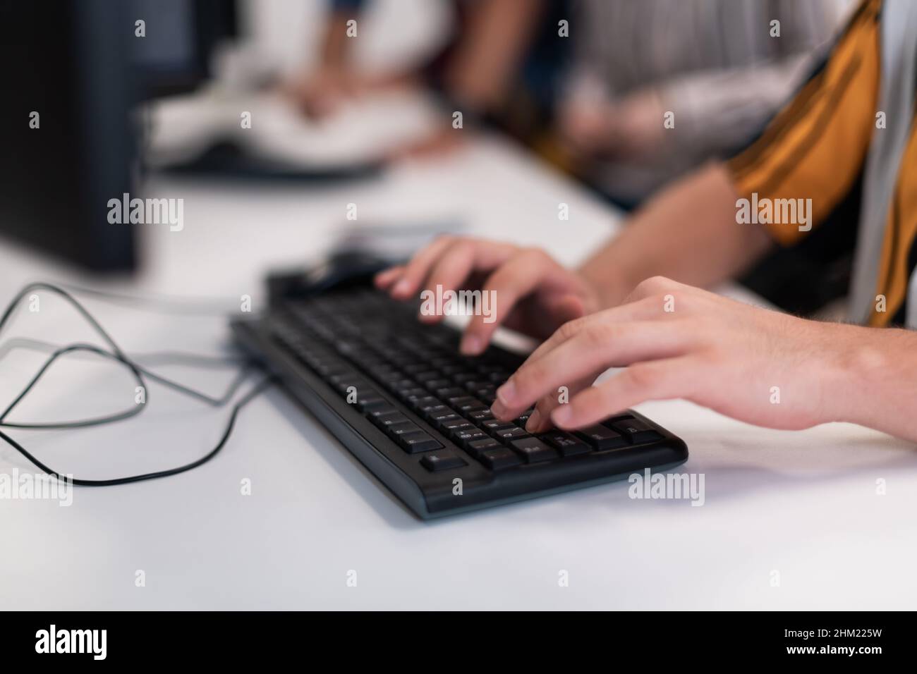 Close up programmer man hand typing on keyboard at desktop pc to input ...