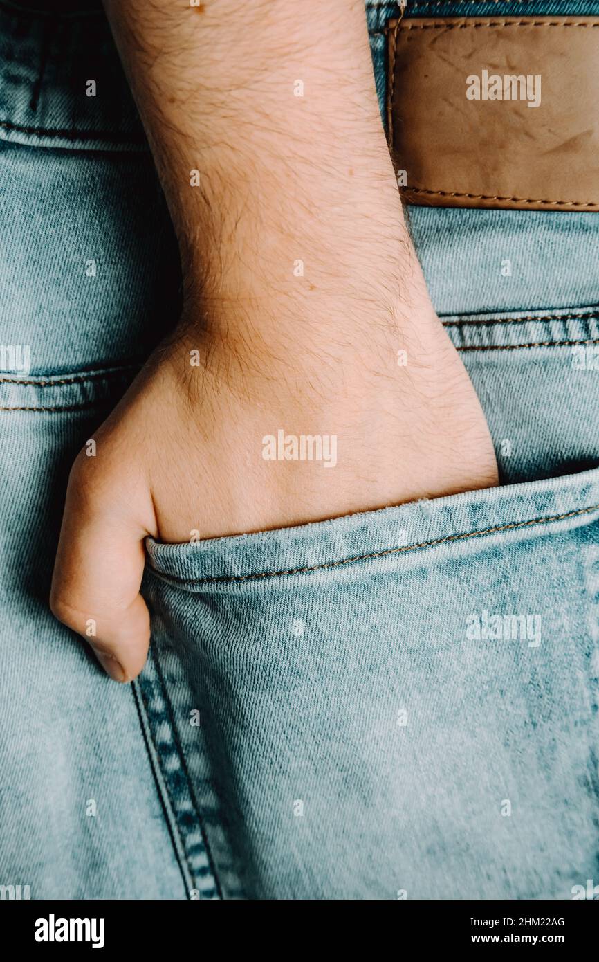 A hand inside of the pocket of a mom jean in a modern style concept ...