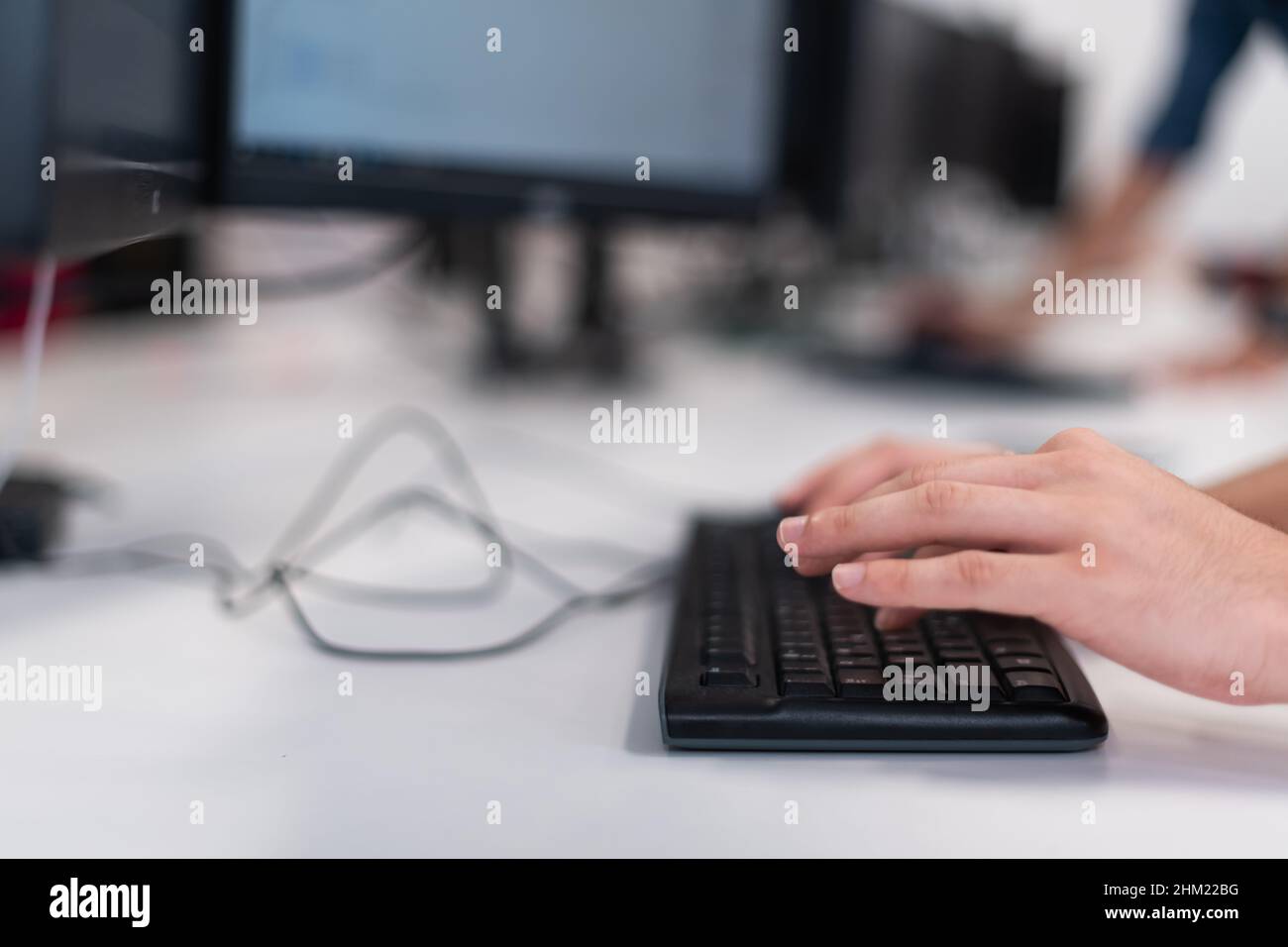 Close up programmer man hand typing on keyboard at desktop pc to input ...