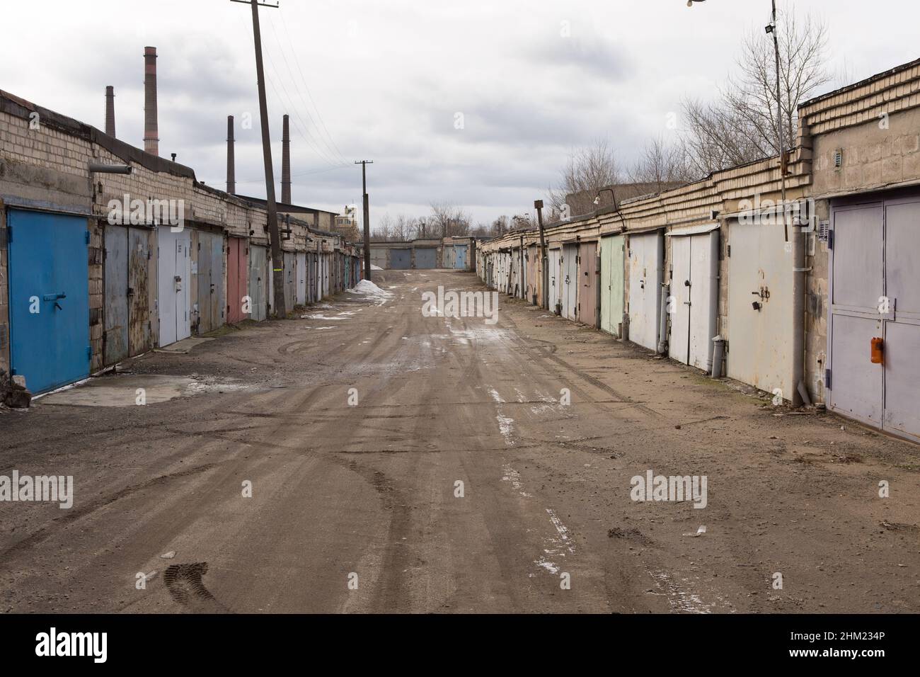 Old rusty multi-colored garages with bad road. Garage cooperative Stock ...