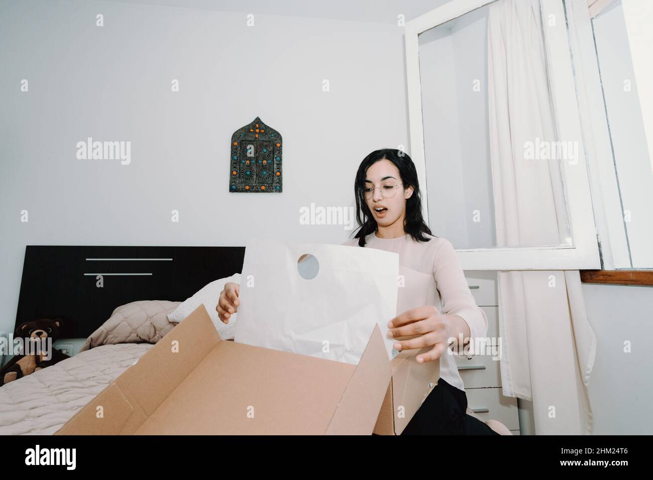 Young woman is opening a cardboard box hi-res stock photography and ...