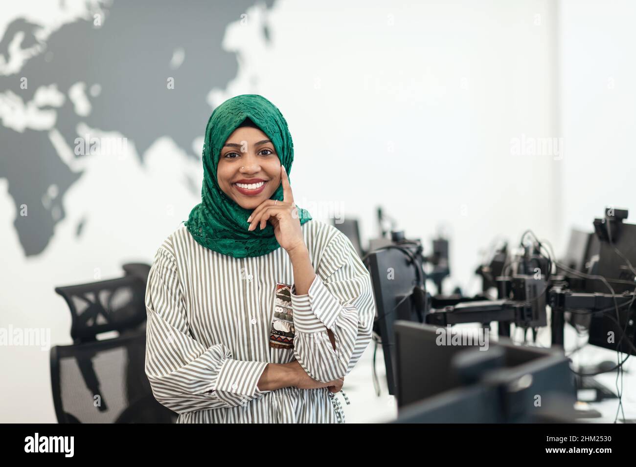Portrait of muslim black female software developer with green hijab ...