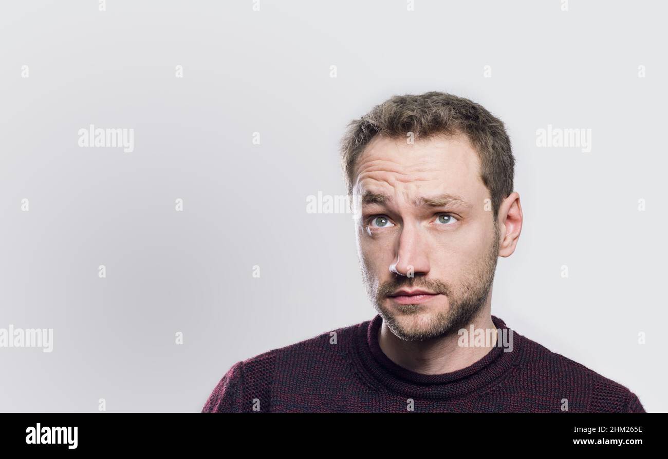 surprised young man looking up Stock Photo - Alamy