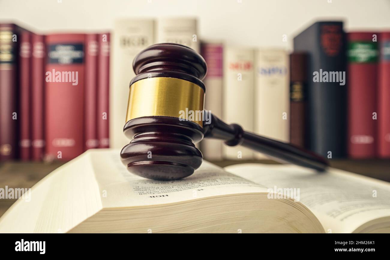 judge gavel on a open law book in a courtroom Stock Photo - Alamy