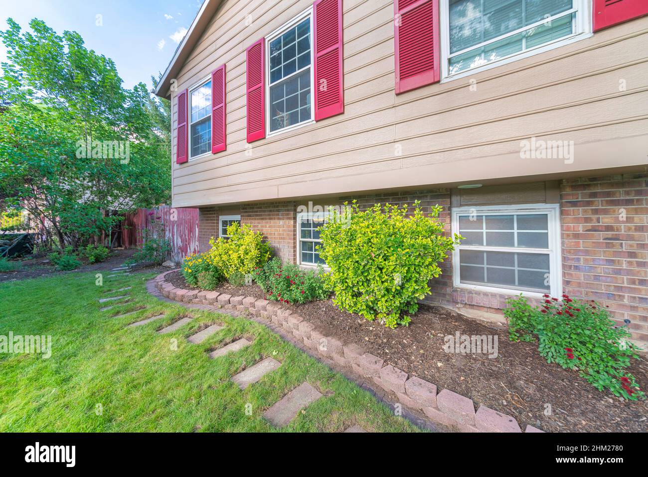 Side yard of a house with concrete walkway on the lawn Stock Photo - Alamy