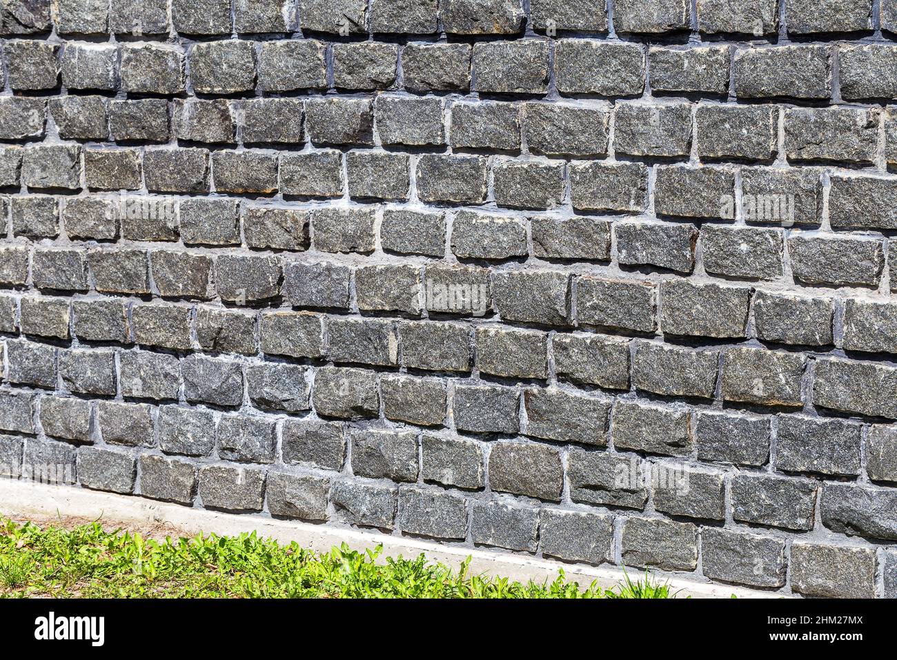 Abstract background of the old wall of black natural stone with cracks and scratches. Landscape ...