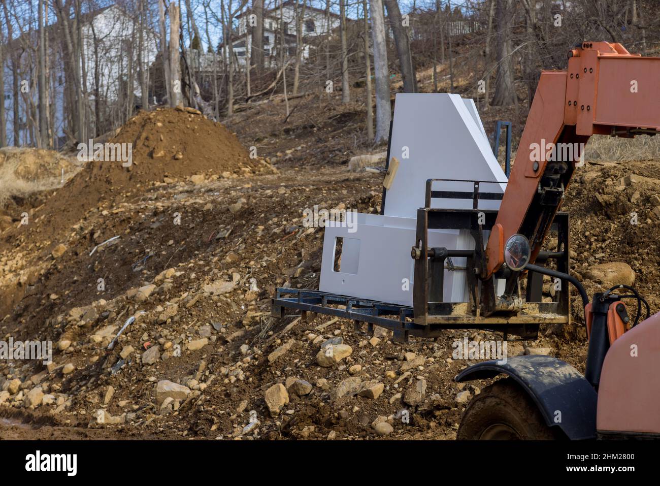 A kitchen granite being lifted by a boom truck forklift with building ...