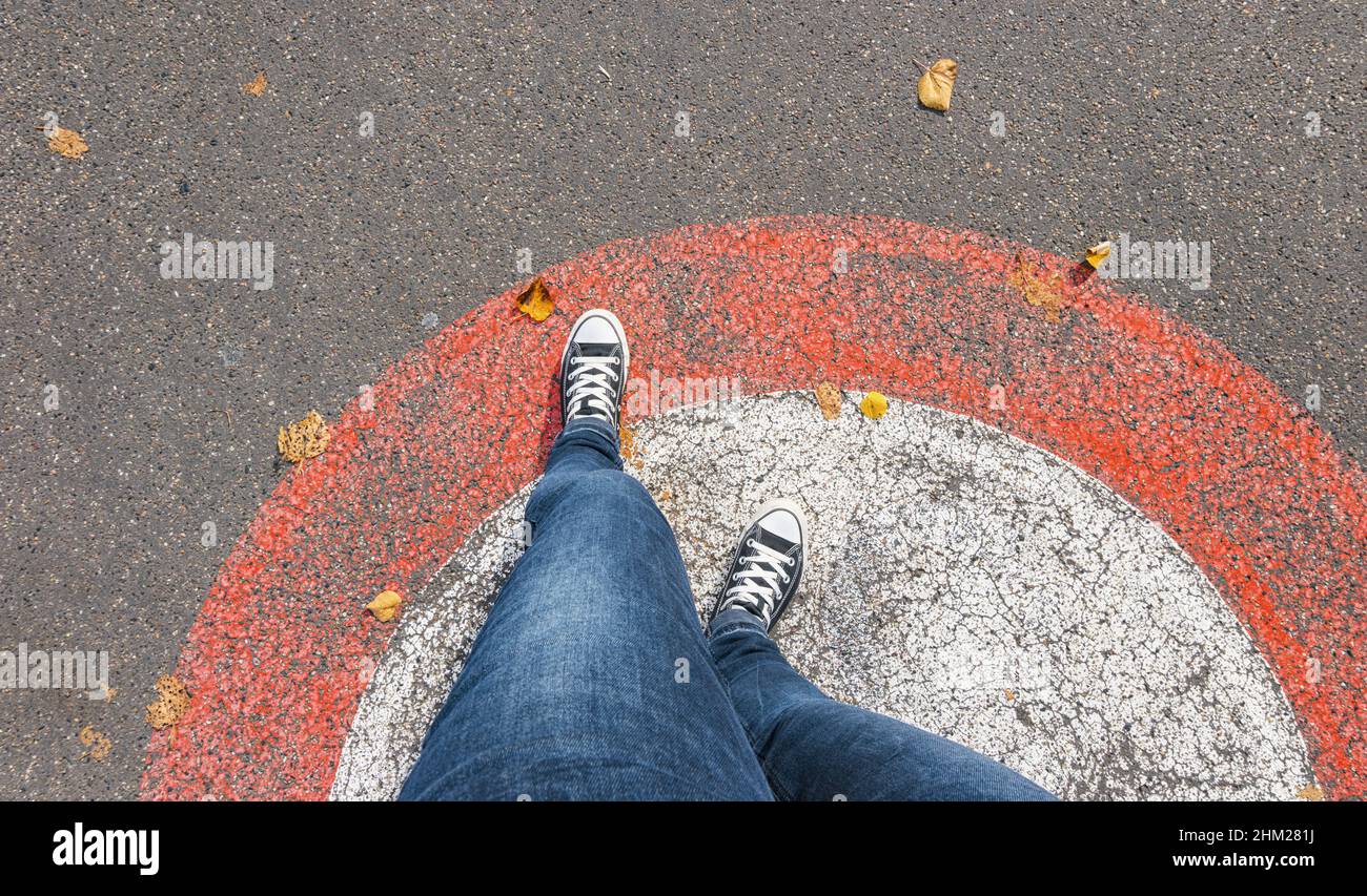 Young woman steps outside a circle at the streets, personal pespective ...