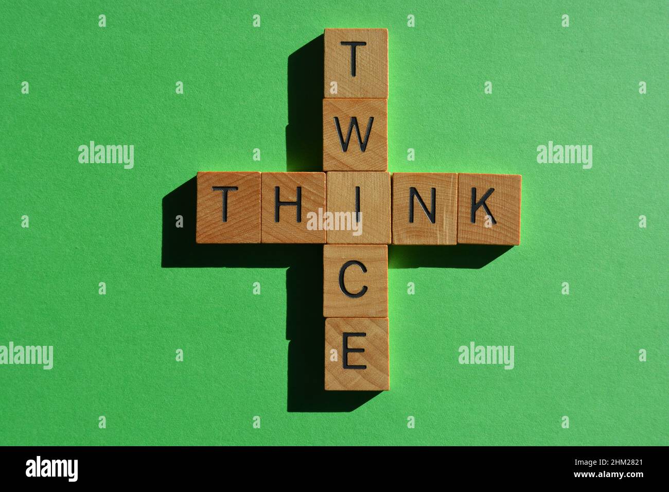Think Twice, words in wooden alphabet letters is crossword form ...