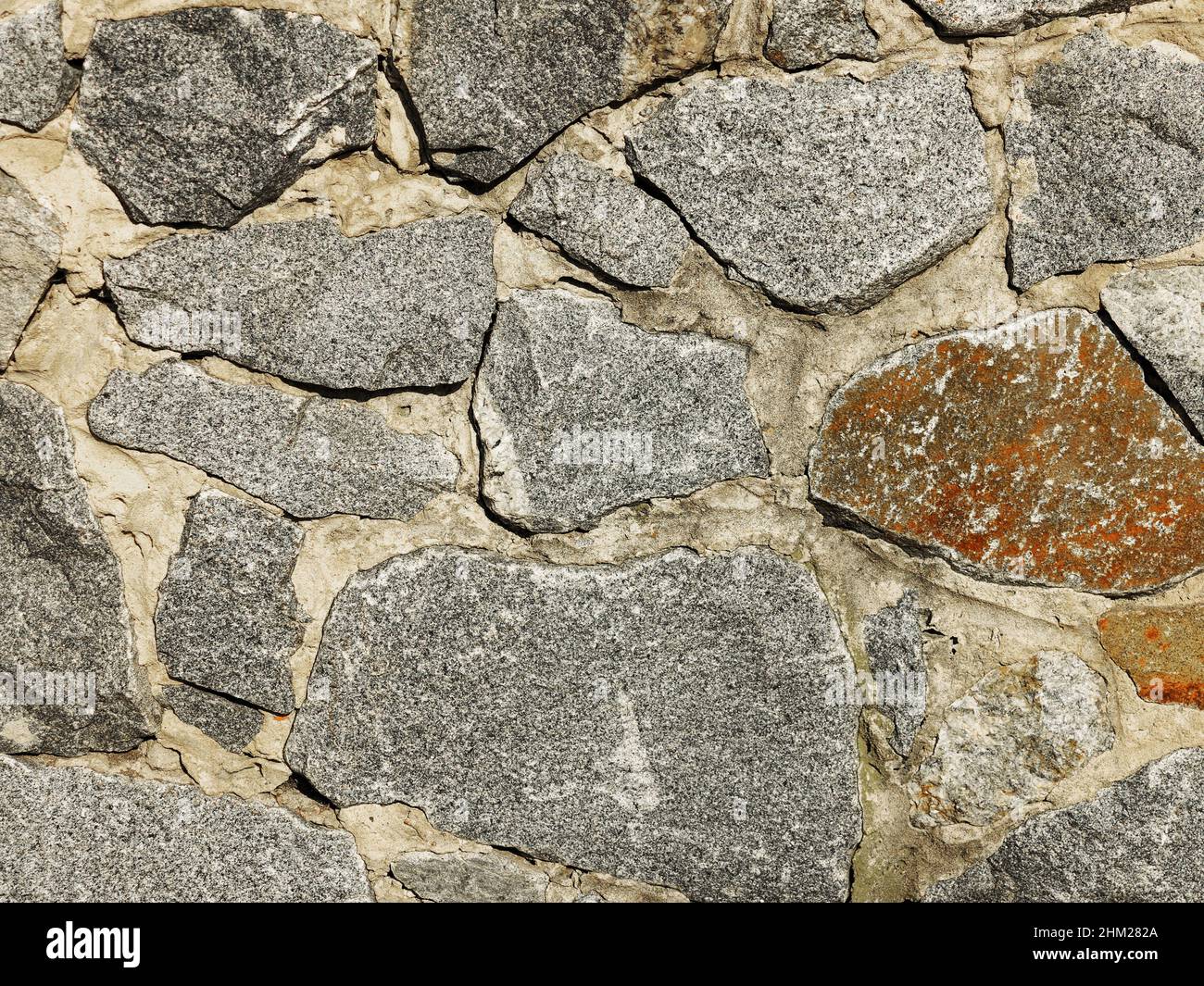 Abstract background of the old wall of black natural stone with cracks ...