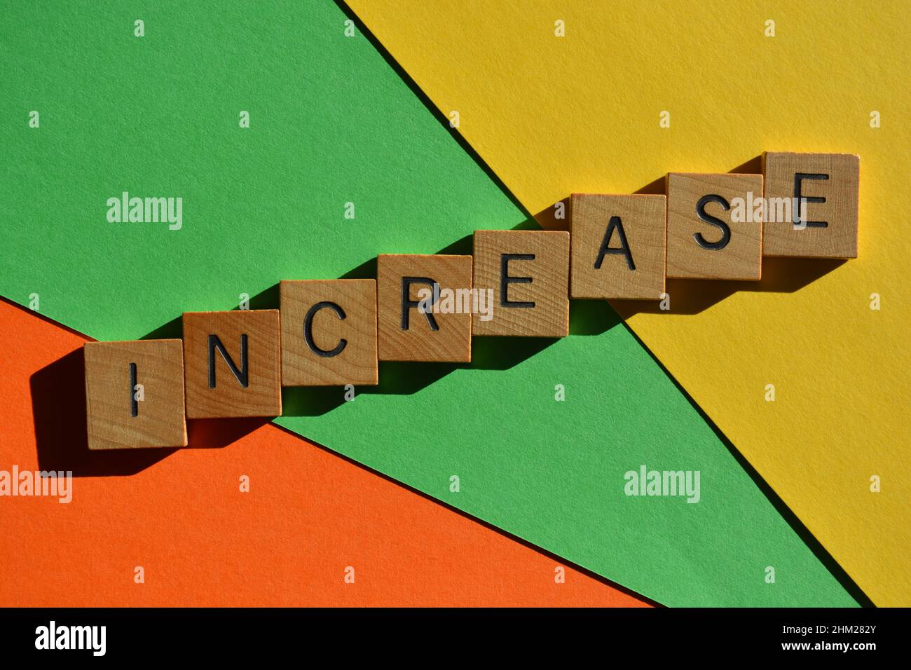 Increase, word in wooden alphabet letters isolated on colourful ...